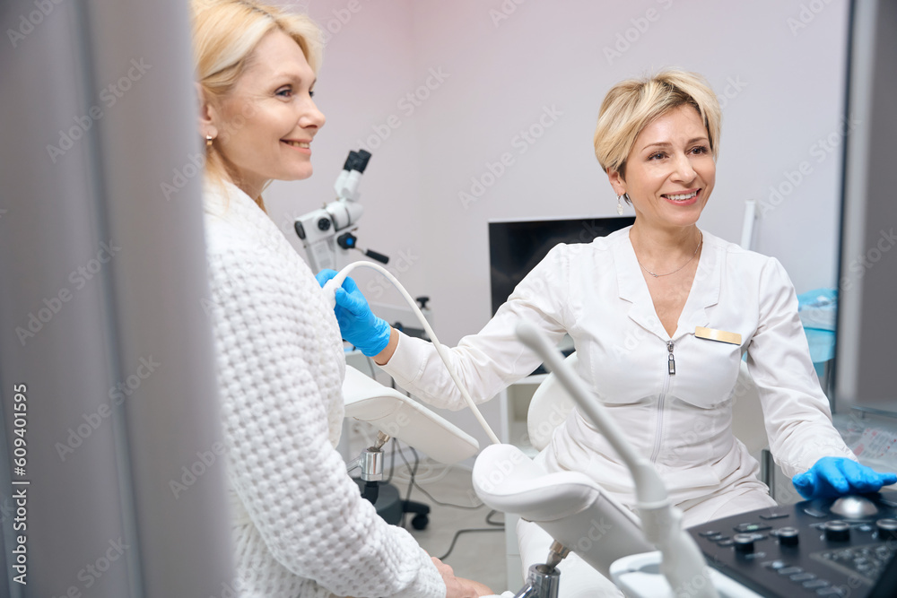 Gynecologist and her patient during procedure for diagnosing mammary ...