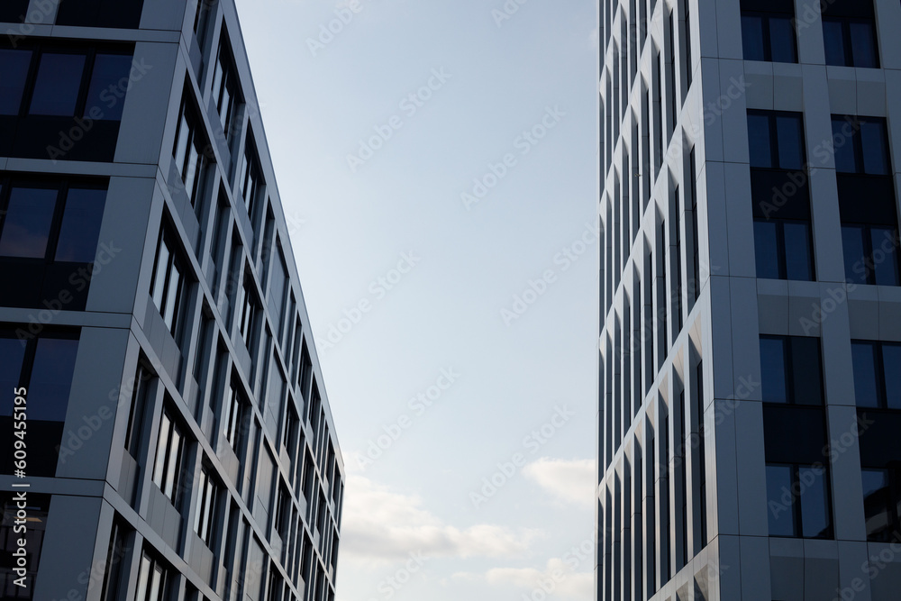 Modern high building business centre with many windows, sky with clouds ...