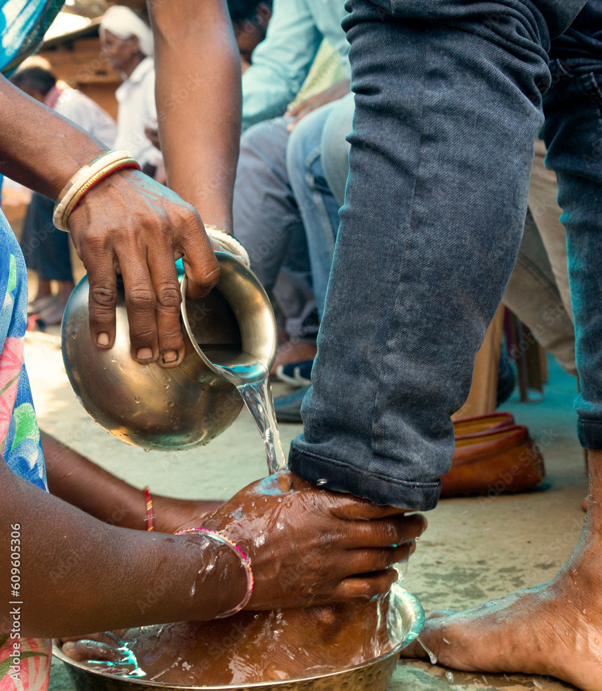 Tribal Culture A woman washing the feet of a guest Stock Photo | Adobe ...