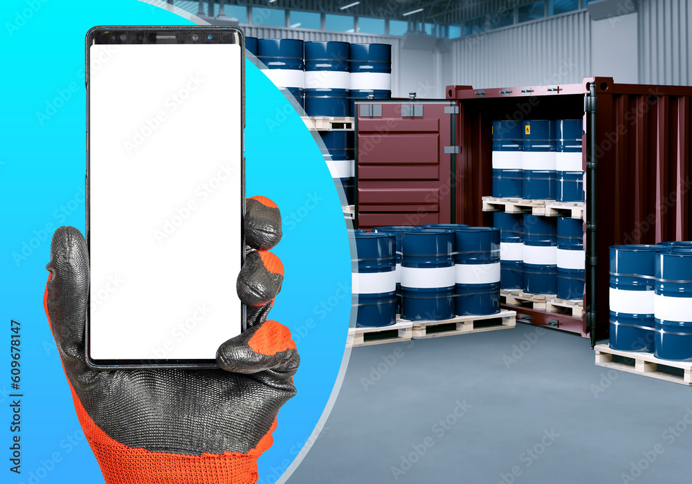 Barrel container. Phone with blank screen. Smartphone in worker's hand ...