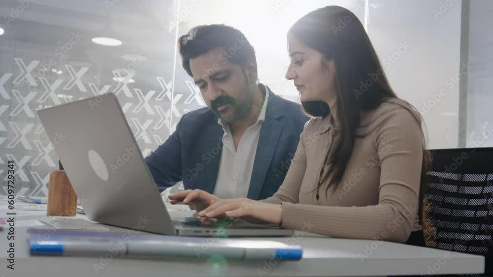 Two modern Indian Asian female and male office colleagues or employees ...