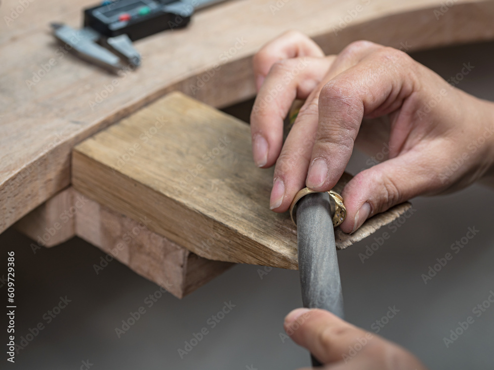 Jeweler polishing inside of the ring with an emery stick Stock Photo ...