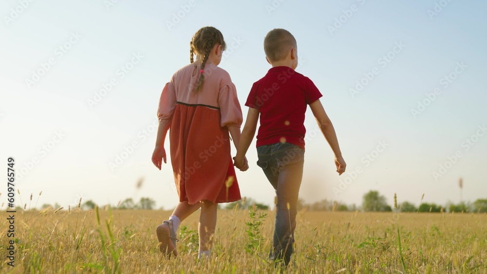 Children walking together in park hand in hand, nature. Happy children ...
