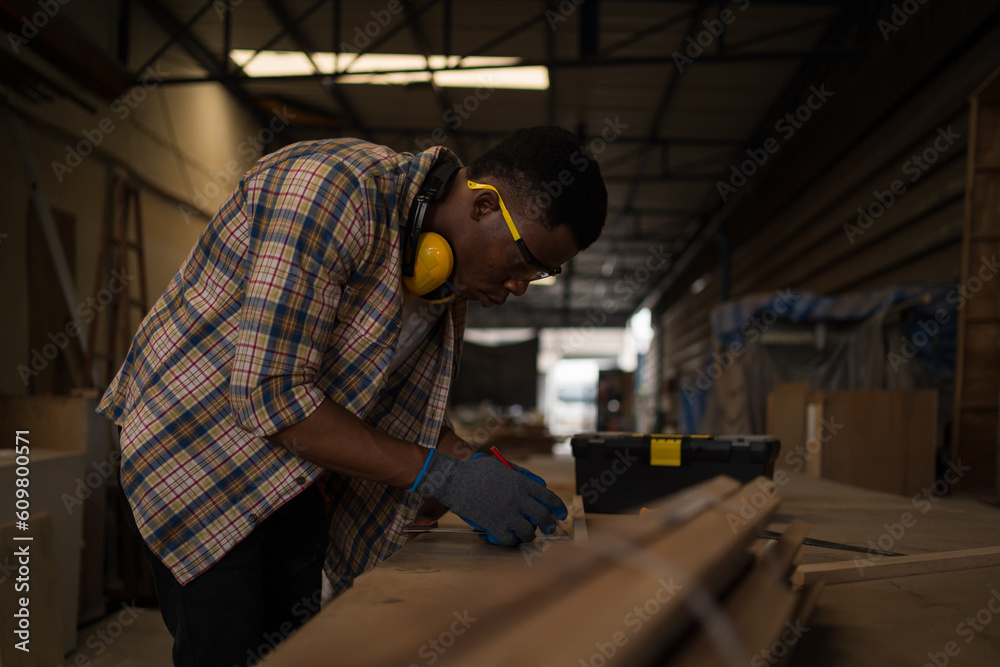 Black African Carpenter professional craftsmen wear safety gear. He was ...