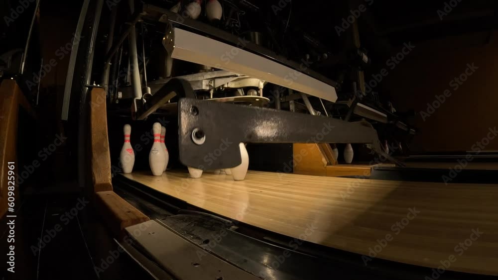 Pinsetter places the bowling pins at a bowling alley - slow motion ...
