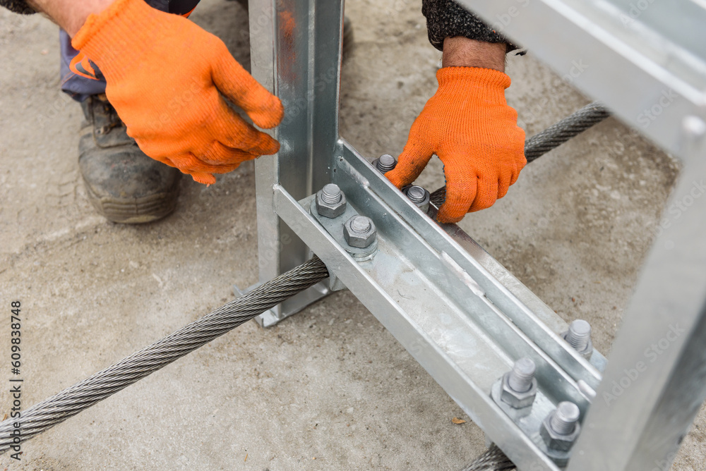 Cable tensioning. Tightening of bolts nuts screw washer in concrete ...