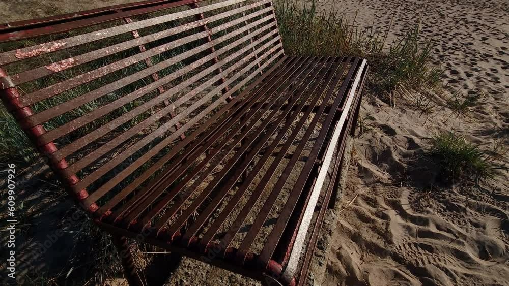 Closer look of the bench on the beach side during the hot sunny day in ...