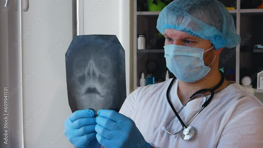 A neurosurgeon analyzes a person's cranial brain in a hospital office ...