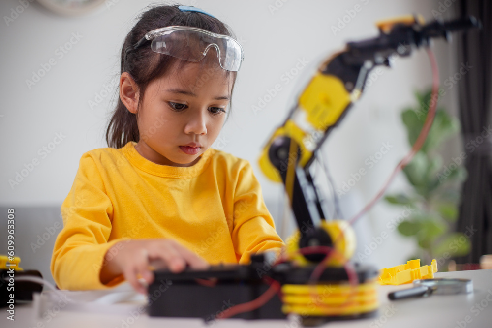 STEM education concept. Asian students learn at home by coding robot arms in STEM, mathematics ...