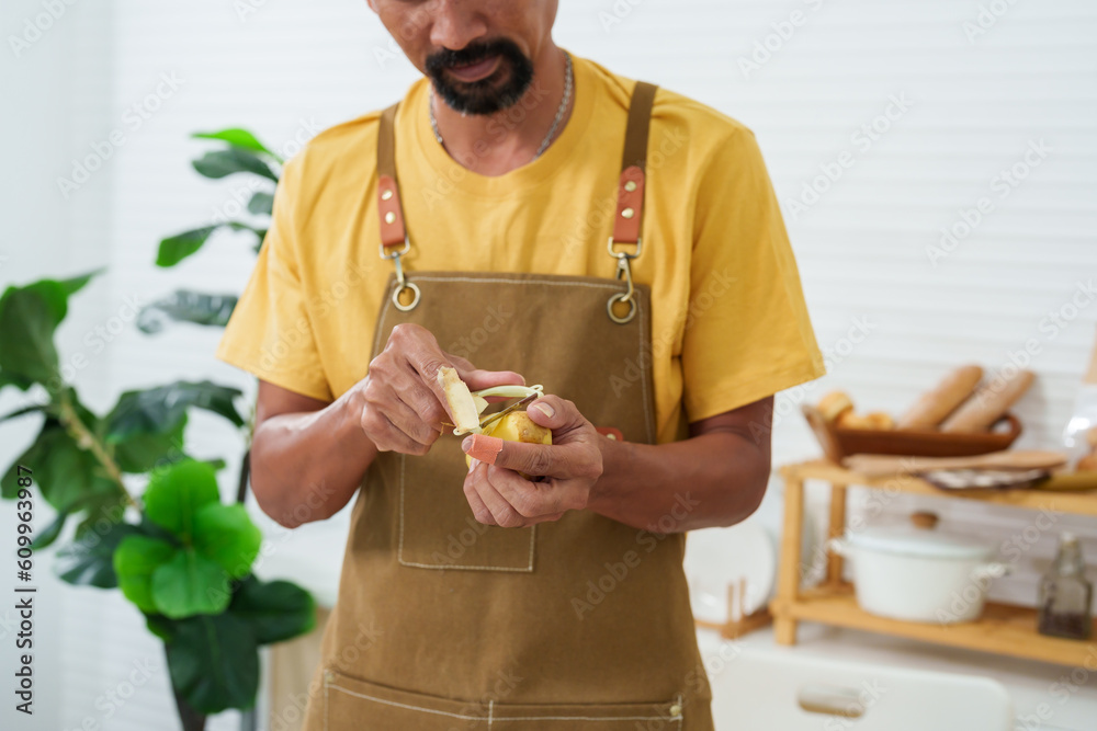 Close-up chef's hand-making breakfast, male chef wearing apron and both ...
