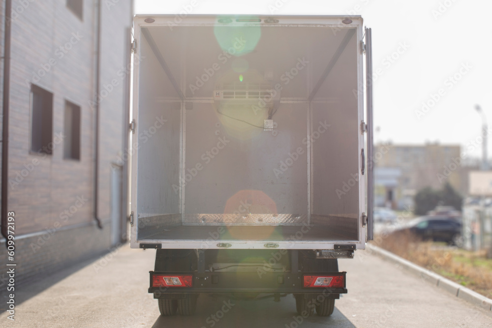 back view of white van with opened rear doors and empty truck Stock ...