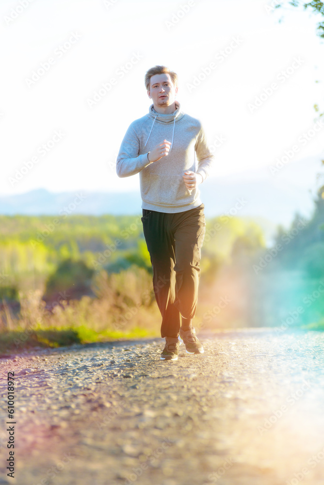 Running man jogging in rural nature at beautiful summer day. Sport ...