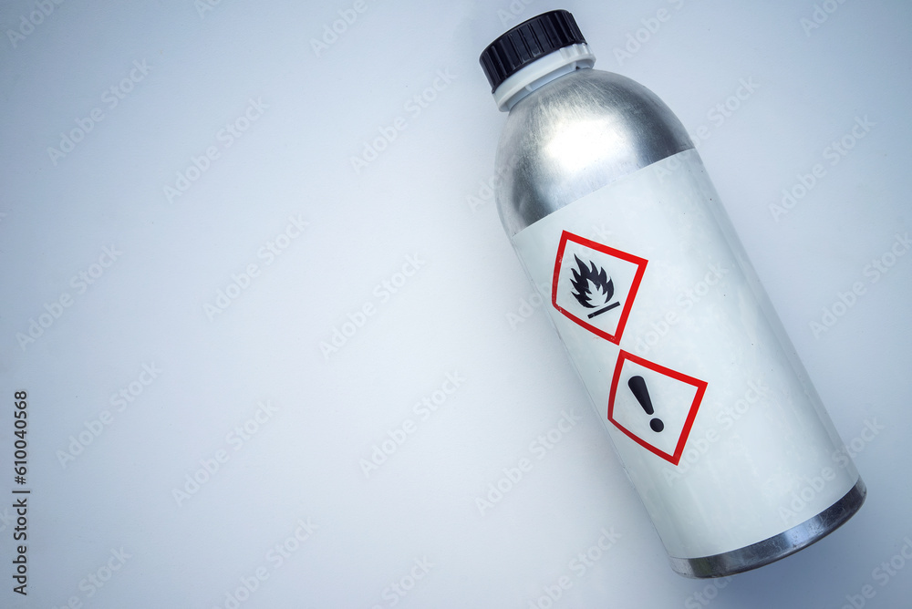 Metal bottle of dichloroethane on a white background.A canister with a ...