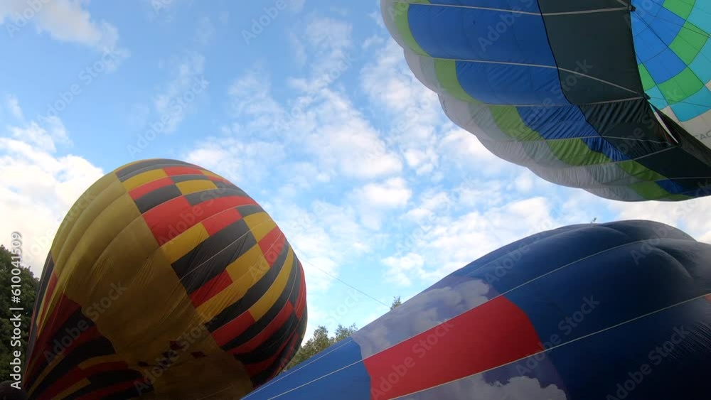 Large hot air balloons filling up hot air and rising at balloon ...