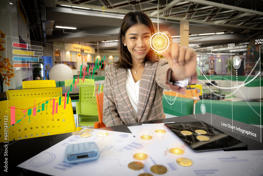 Beautiful business woman holding a coin and show economic growth graphs ...