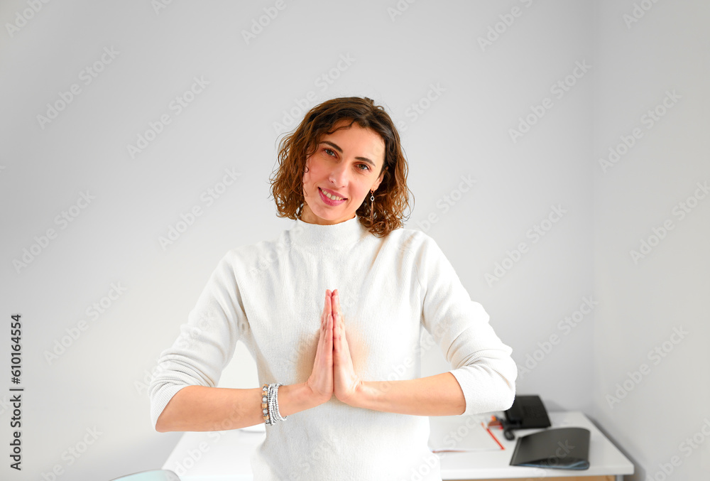 Pretty smiling female giving thanks to the universe holds hands in ...