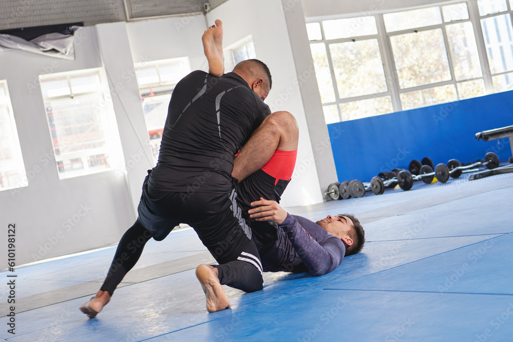 Men are training, martial arts and fitness in gym with combat, jiu ...