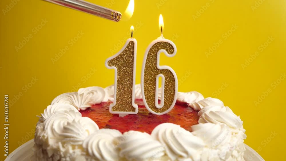 A candle in the form of the number 16, inserted into the holiday cake ...