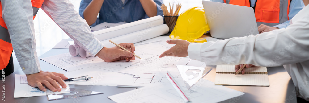 Engineer partner drawing and working on blueprint design together on ...