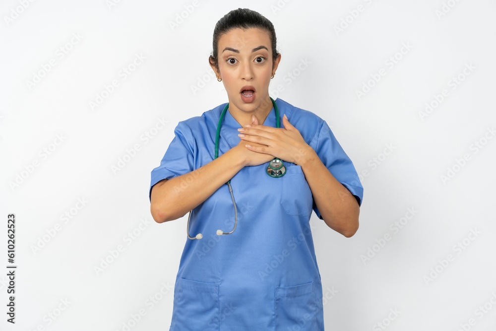 Scared Beautiful doctor woman standing over white studio backgrou looks ...