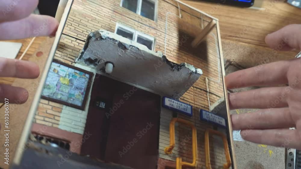 A master of miniatures showcases a small brick wall with a window, an ...