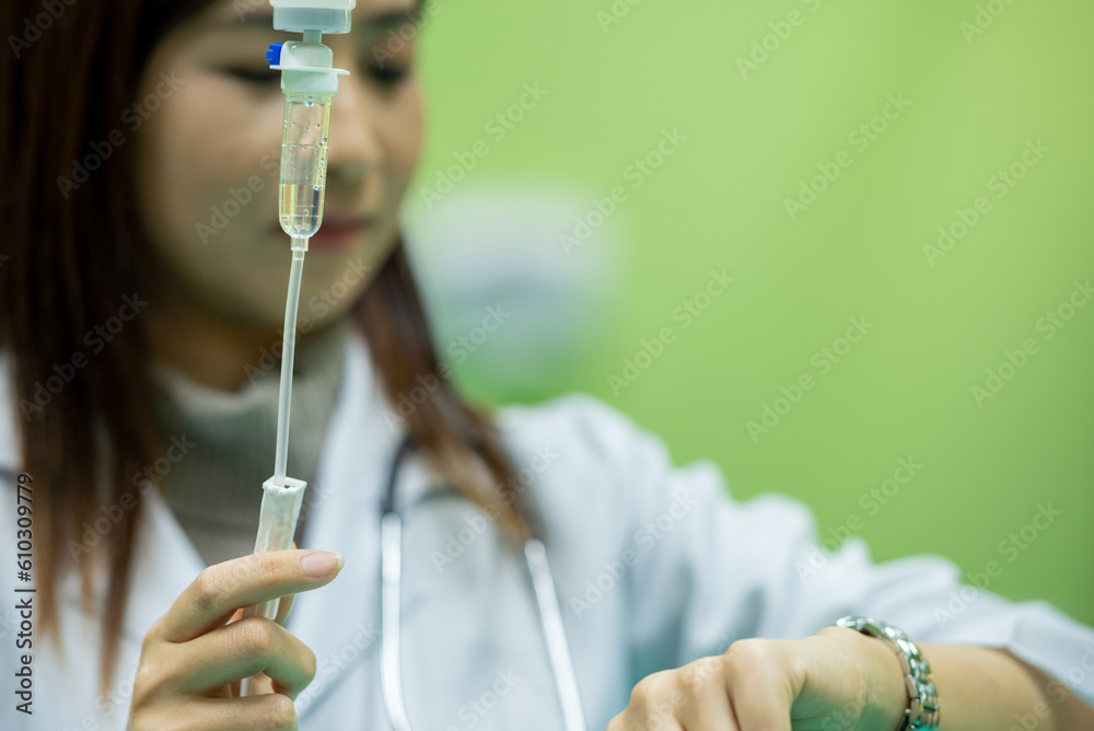 Woman doctor monitor Adjust the drip rate feed of saline dripping ...