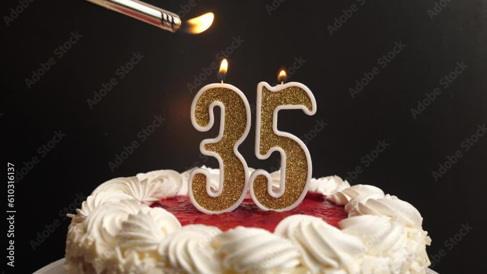 A candle in the form of the number 35, inserted into the holiday cake ...