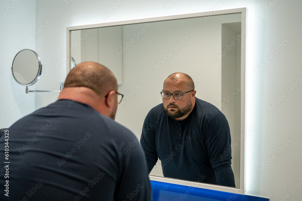 Sad fat lonely man looks in mirror bath, thinks change life, problems ...