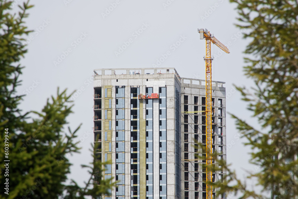 Tower crane next to a modern high-rise multi-storey building under ...