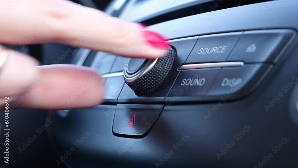 Woman hand turning volume button of a car audio system in the car Stock ...