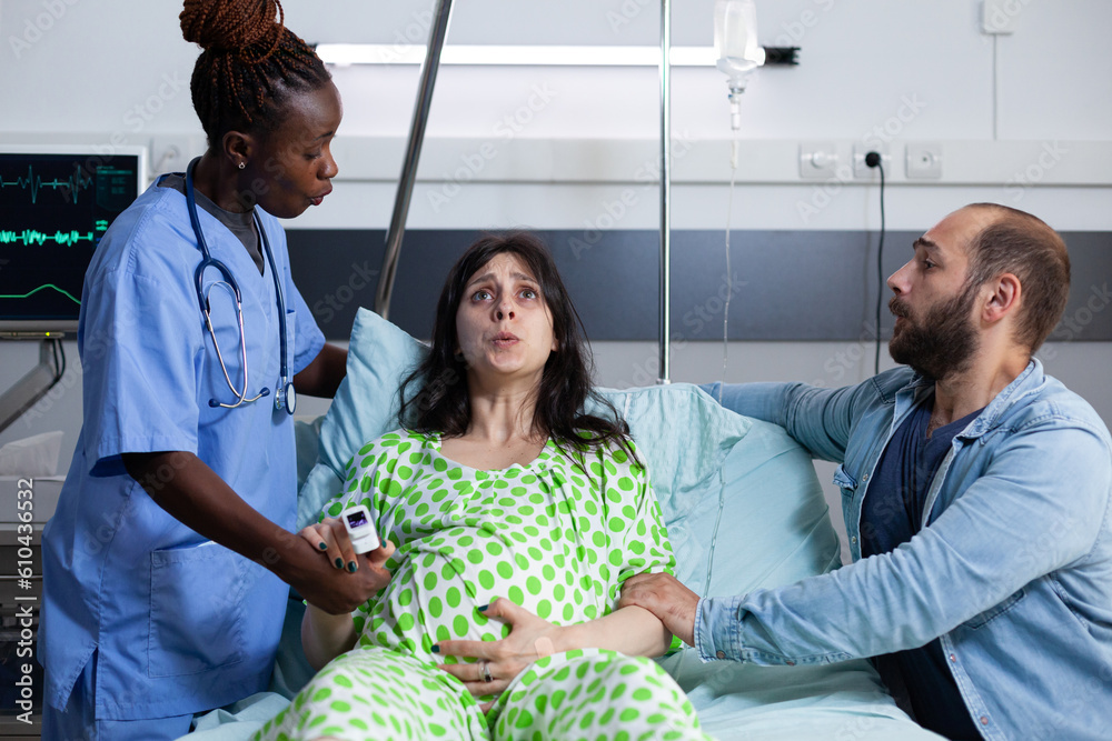 Pregnant woman in labor suffering from painful contractions lying in ...