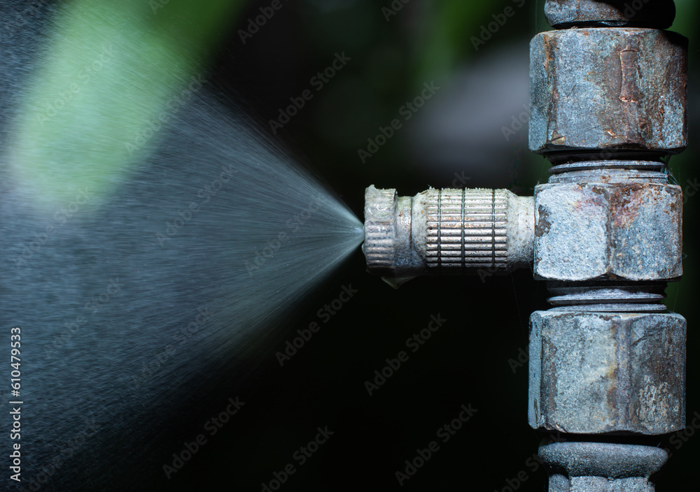High-pressure spray nozzle or fog mist for garden decoration lowers the ...