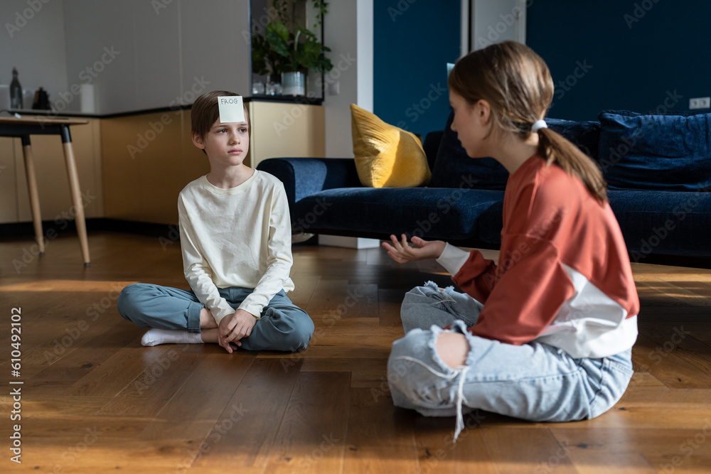 Guess who I am. Small children friends playing guessing game with ...