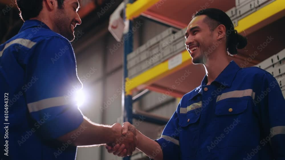 Two smart engineer worker in uniform safety wear helmet congraturation ...
