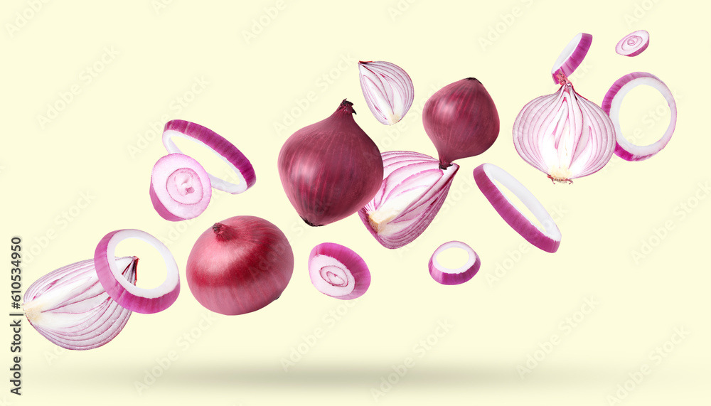Whole and cut fresh red onions falling on beige background Stock Photo ...