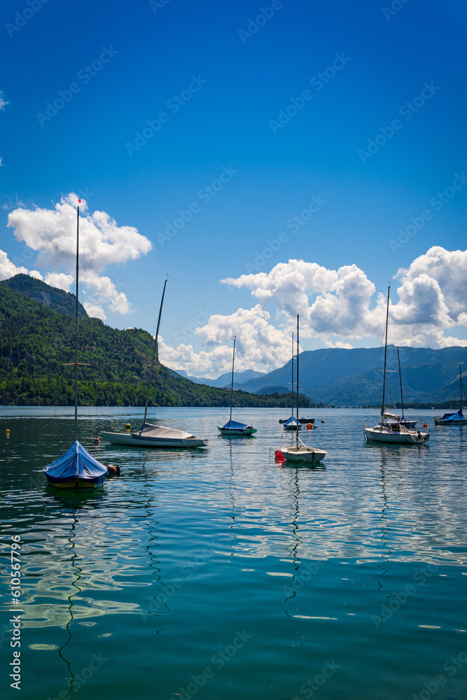 Small boats floating in a boat harbor at a turquoise beautiful lake ...