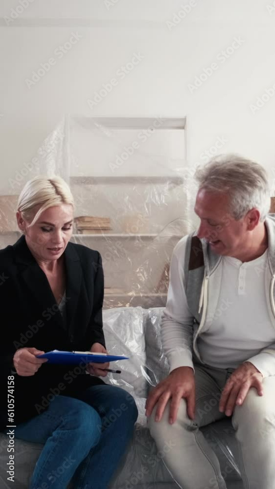 Vertical video. Rental agreement. Moving new home. Happy guy signing ...