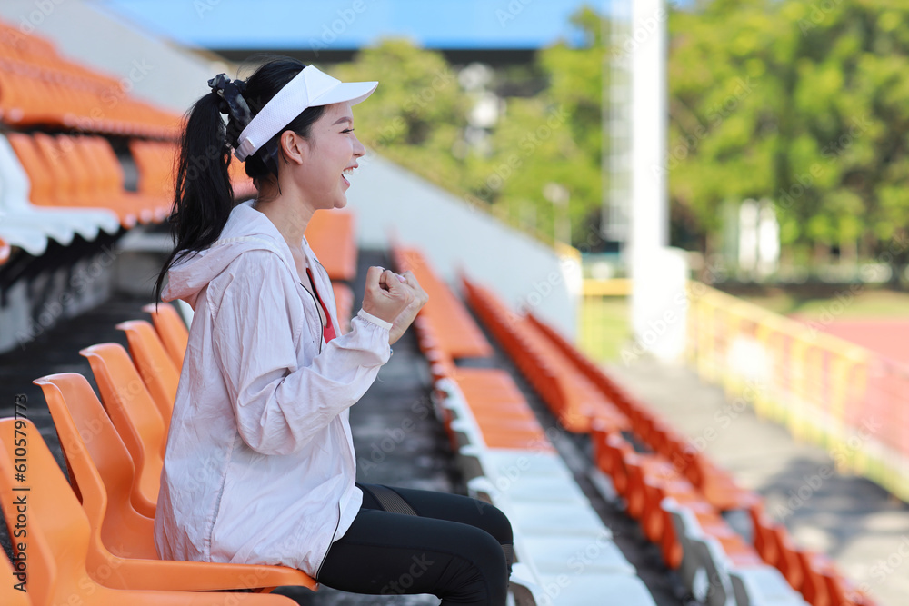 Portrait of happy and exciting young female asian sport fan cheering ...