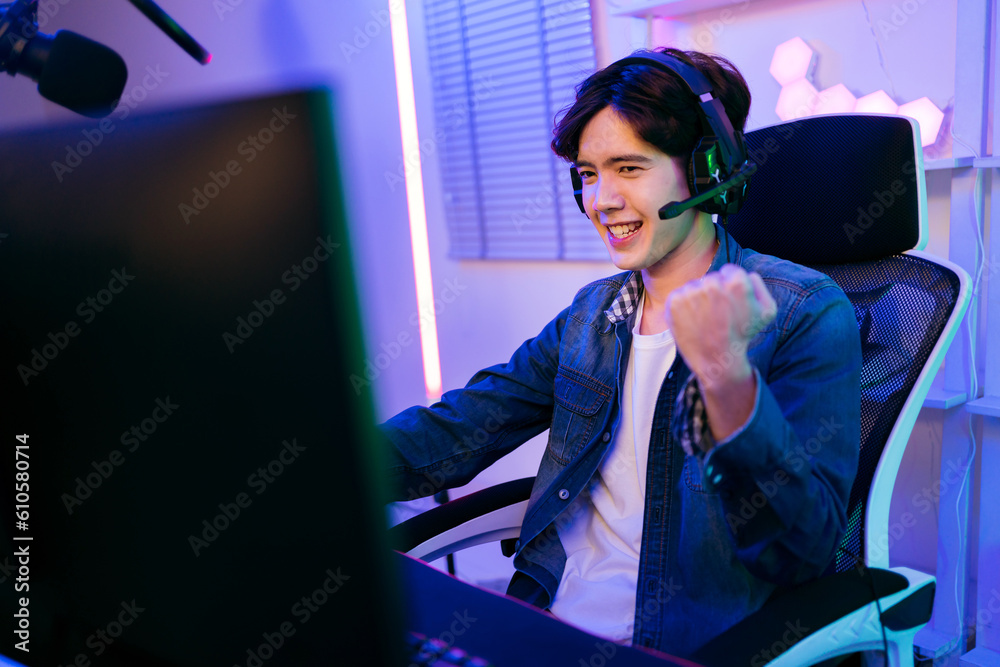 Portrait of Asian male gamer celebrating victory in front of the gaming ...