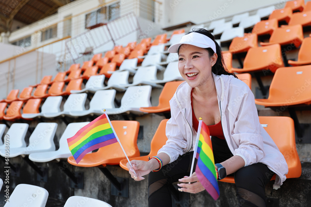 Happy and excited young female asian transgender LGBT sport fan ...