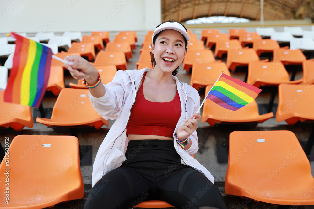 Happy and excited young female asian transgender LGBT sport fan ...