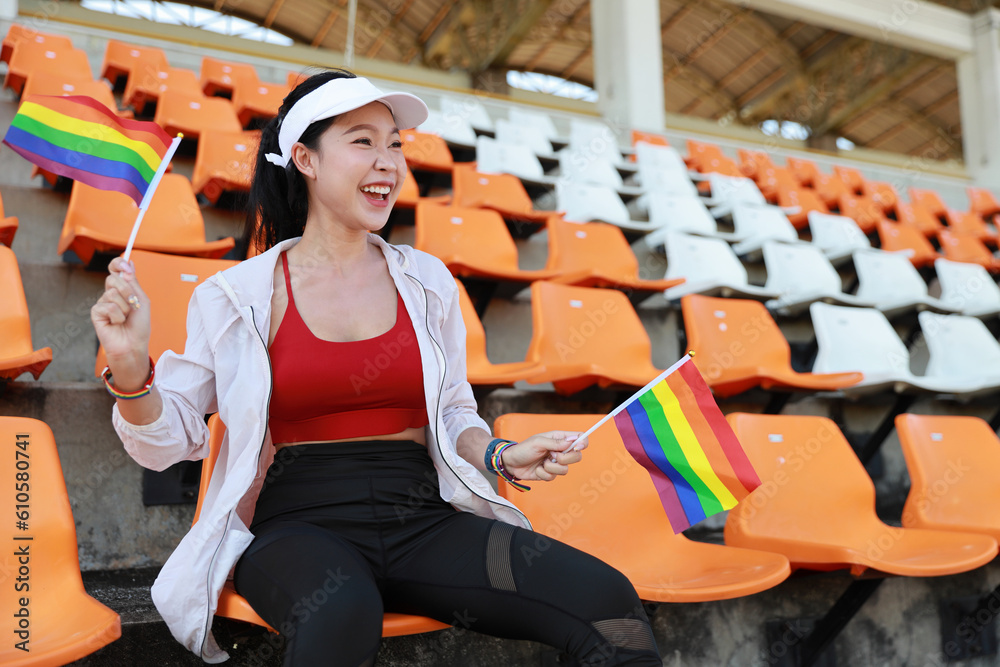 Happy and excited young female asian transgender LGBT sport fan ...