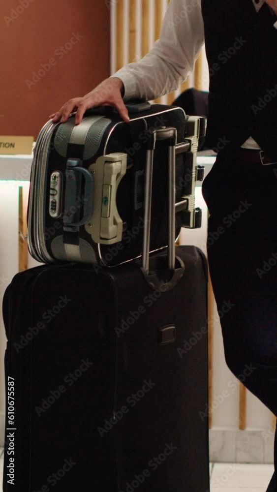 Vertical Video Cheerful smiling professional bellboy in formal attire ...