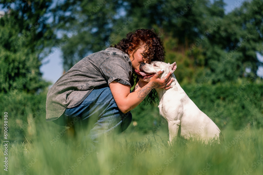 Dog Psychologist Calms A White Dog Of A Large Pit Bull Breed In The dog-psychologist-calms-a-white-dog-of-a-large-pit-bull-breed-in-the