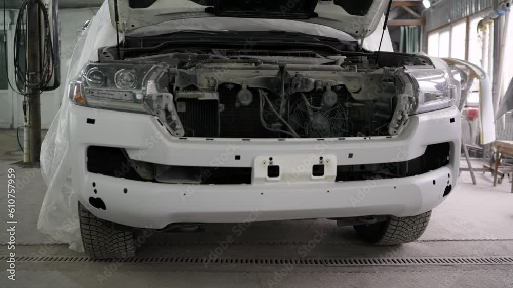 The frame of a powerful white car with body parts removed. Car bumper ...