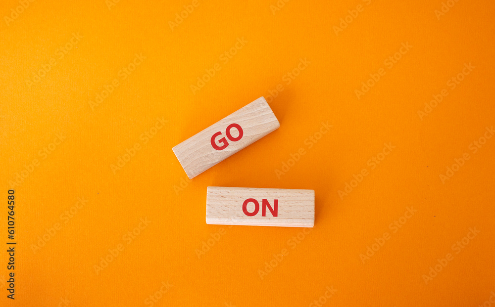 Go on symbol. Wooden blocks with words Go on. Beautiful orange ...