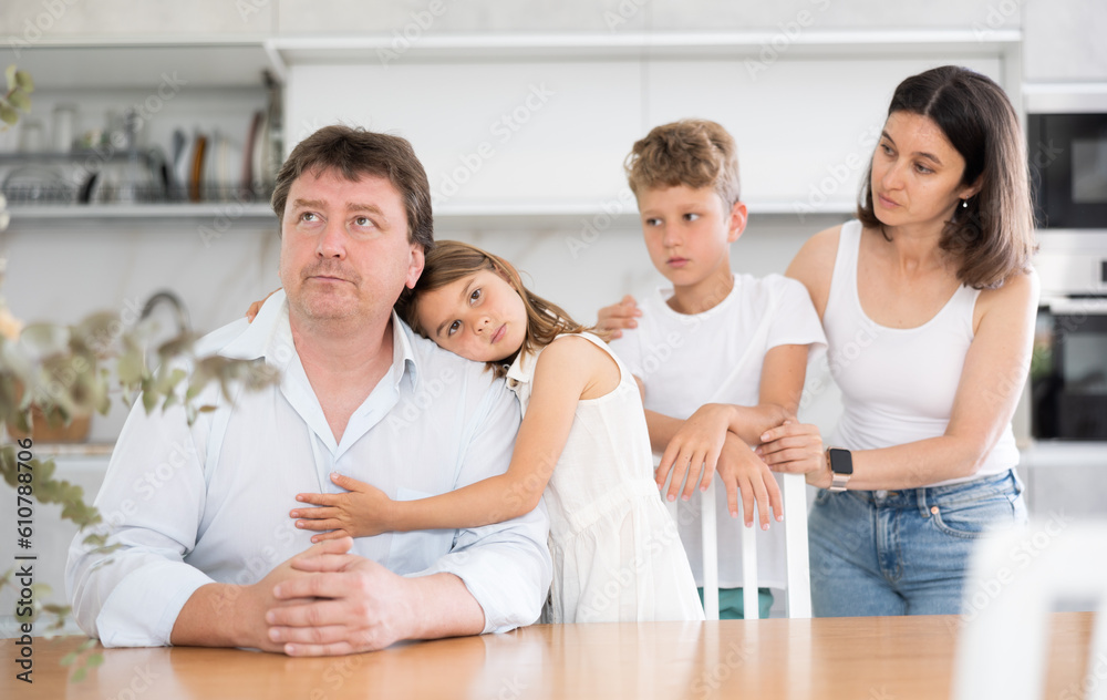 Saddened by bad news, man is sitting in kitchen surrounded by ...