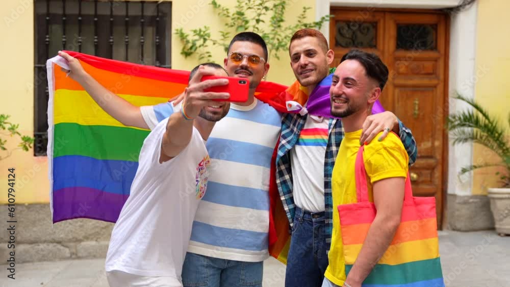 Homosexual male friends having fun at gay pride party taking a selfie ...