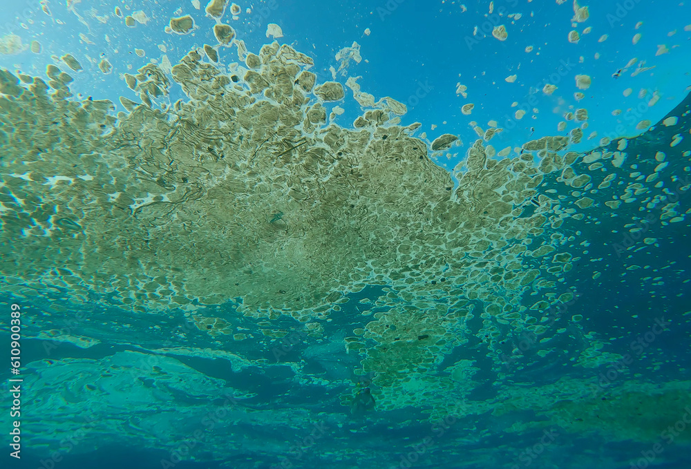 An oily fatty layer of garbage slowly drifts on surface of sea. Waste ...