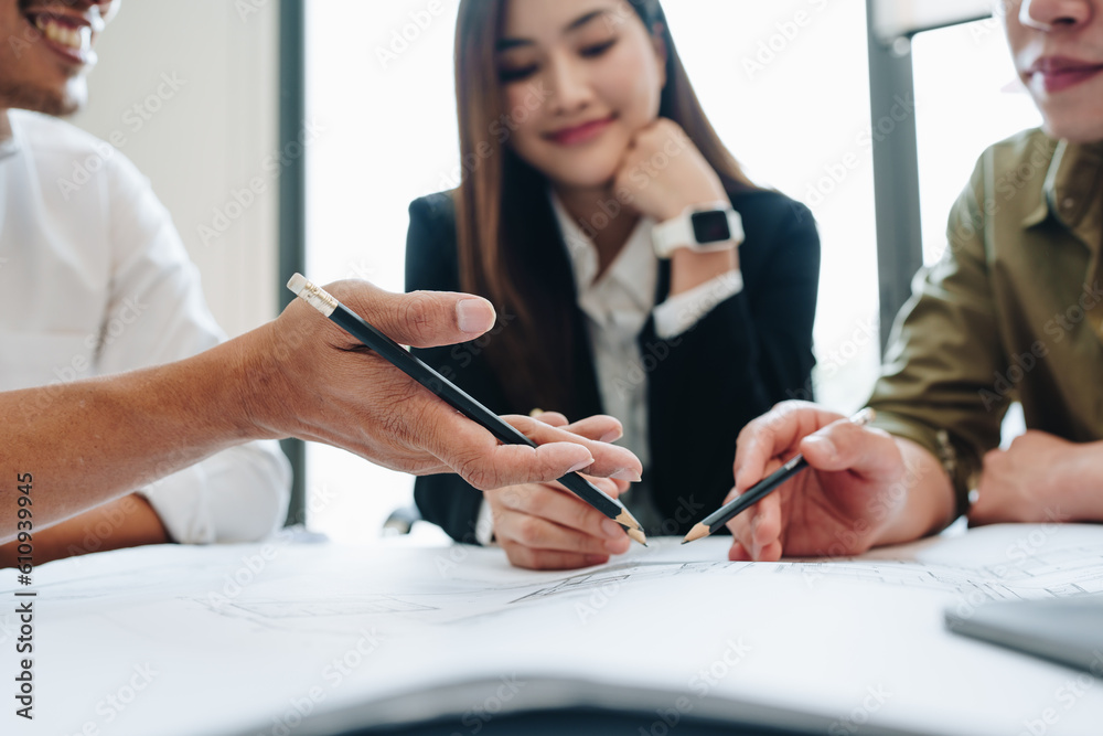 multi ethnic engineer brainstorming and measuring for cost estimating ...